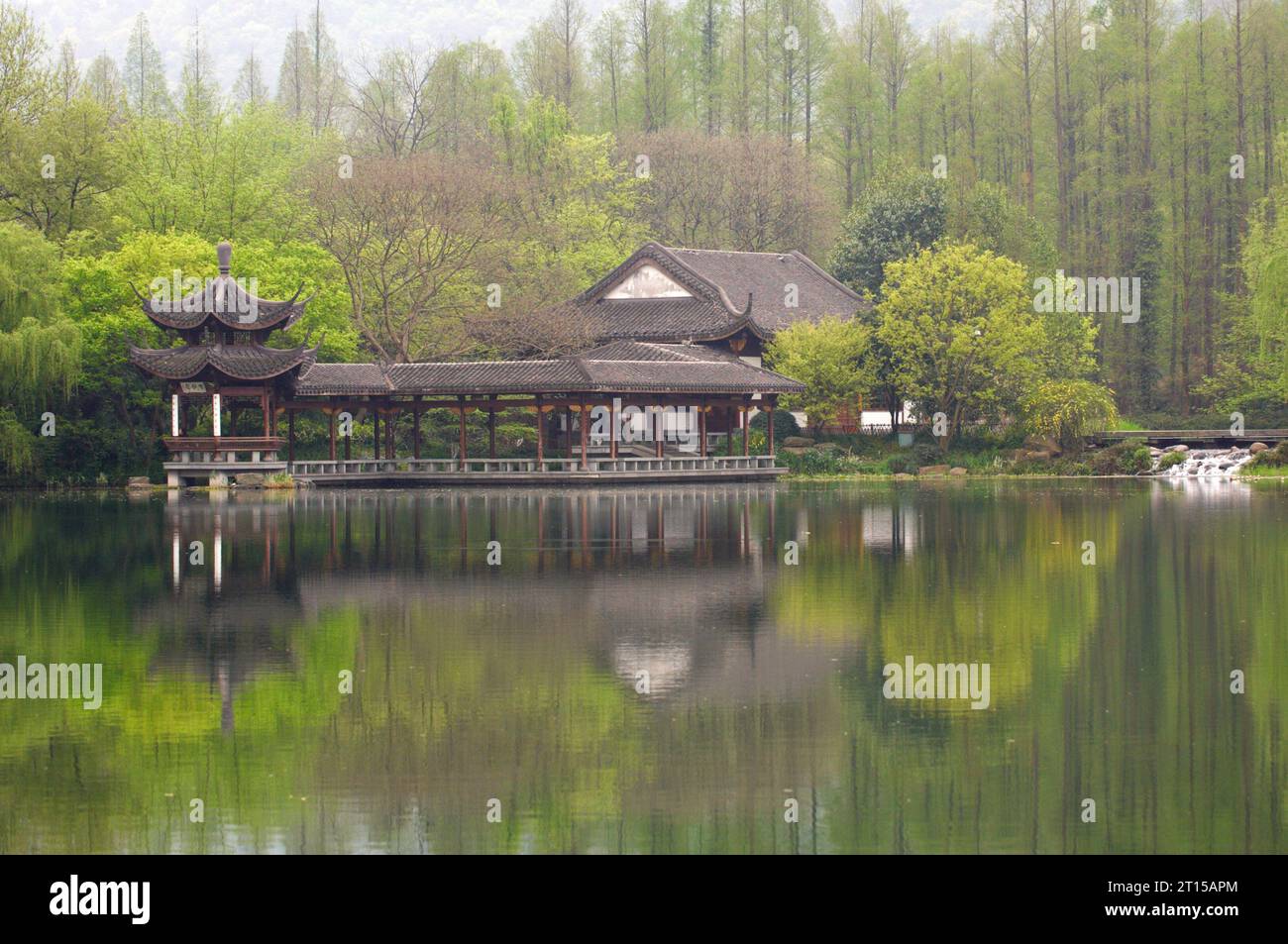 Chinese traditional bridge with pavilion on the coast of West Lake ...