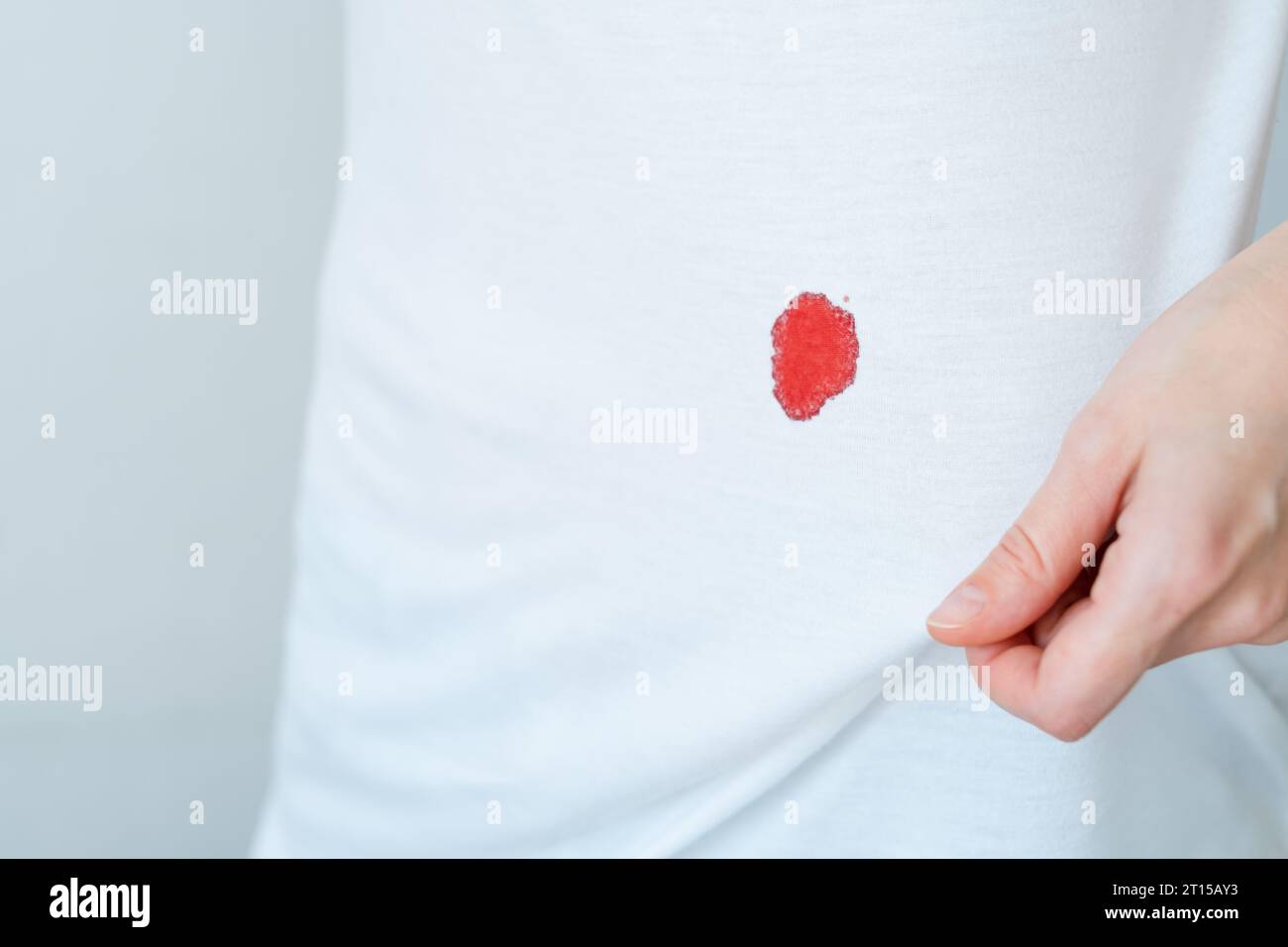 Drop stain of blood on a white cloth. Dirty stain for cleaning concept ...