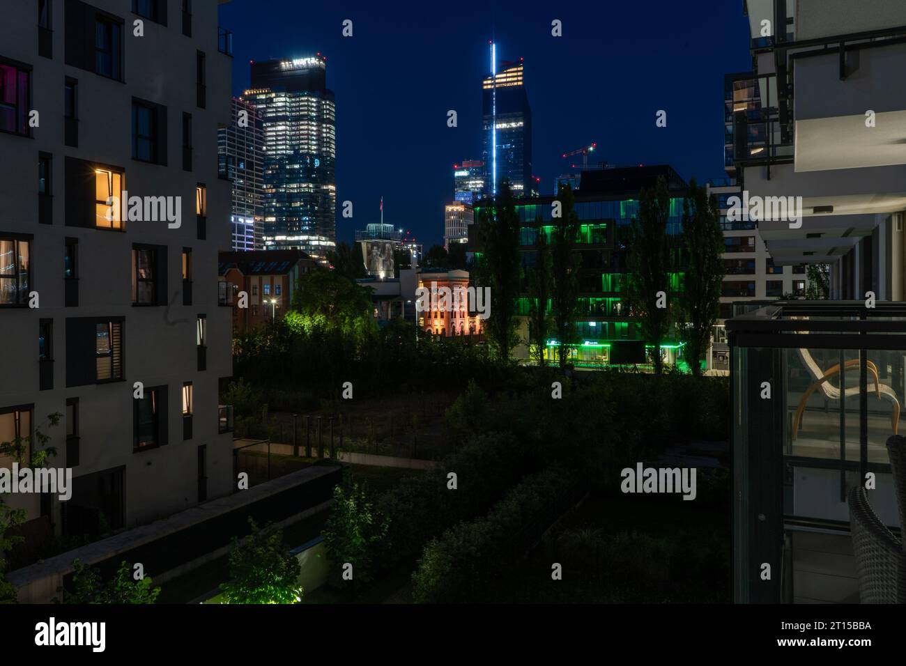 Night city lights. View of the Warsaw Uprising Museum. New houses glow ...