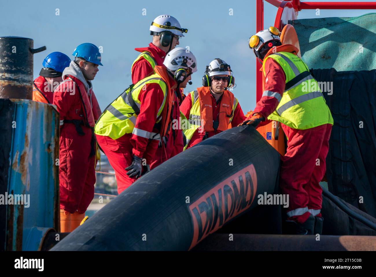 Crew onboard the Jif Worker, a multi-cat vessel, deploy a heavy duty ...