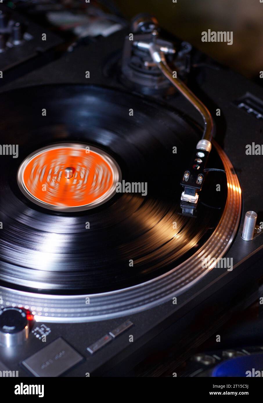 Dj turntables needle cartridge on black vinyl record with music. Close ...