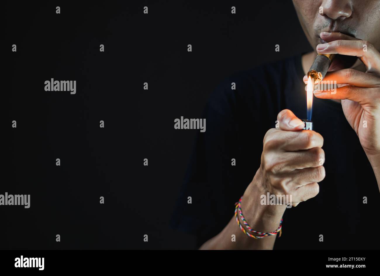 A man in dark room smoking a cigar Stock Photo - Alamy