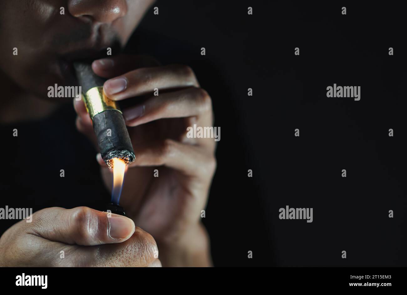A man in dark room smoking a cigar Stock Photo - Alamy