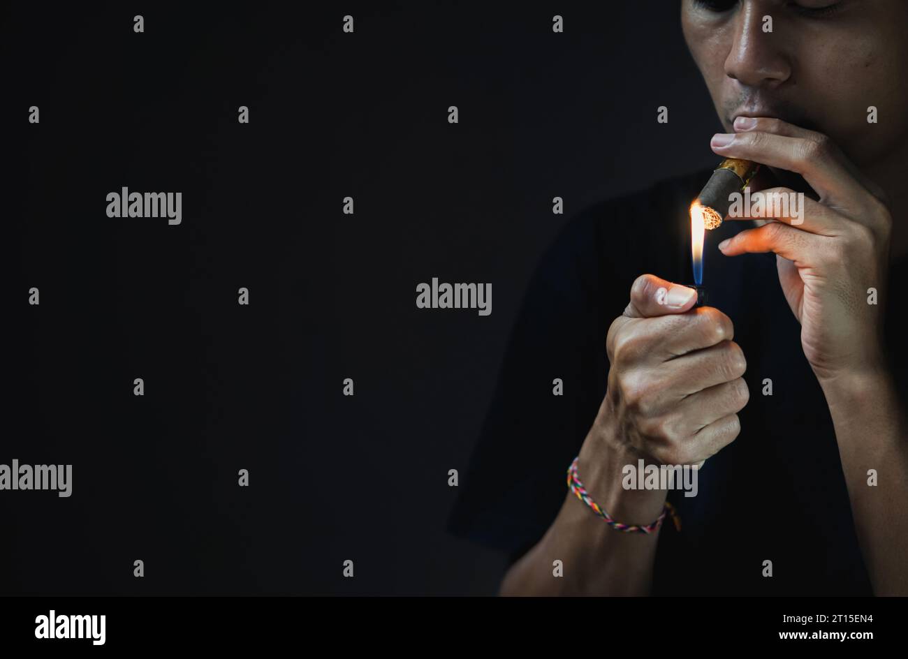 A man in dark room smoking a cigar Stock Photo - Alamy