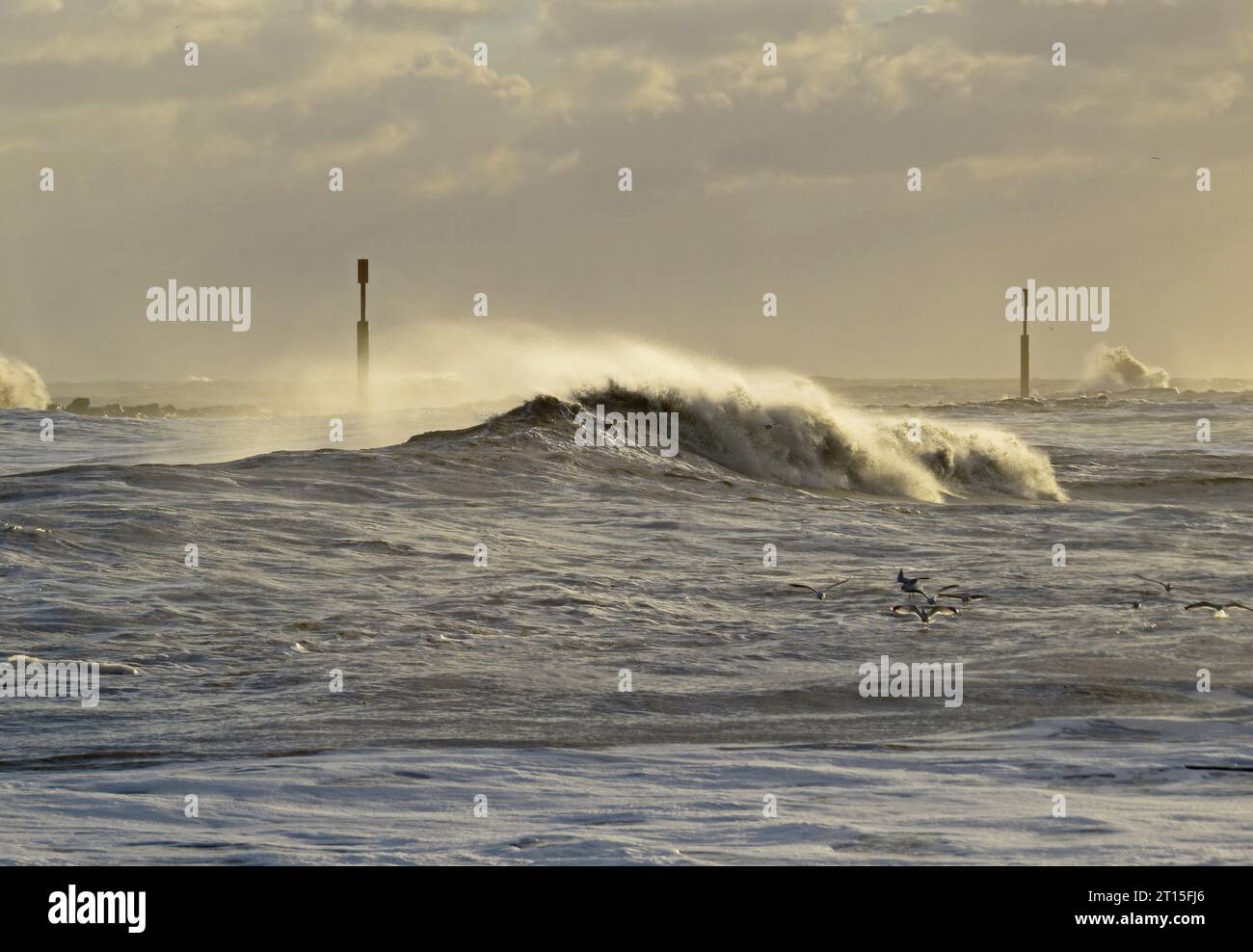 waves breaking on sea defences during a 'North Sea tidal surge' Eccles-on-Sea, Norfolk, UK ...
