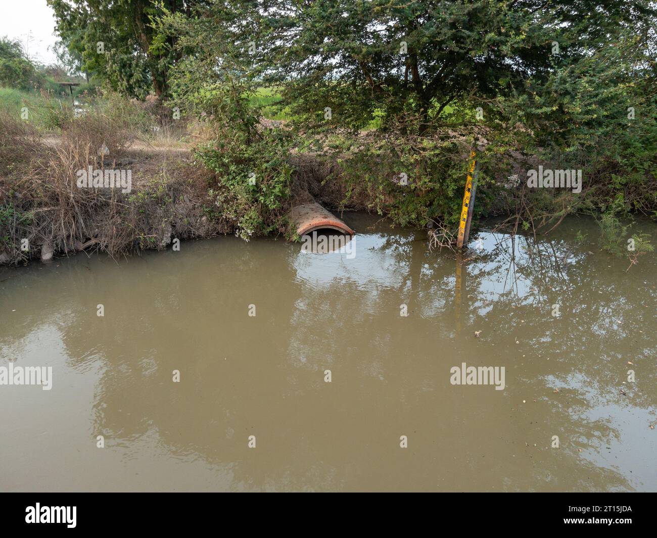 The irrigation canal with the water level gauge indicator to show the ...