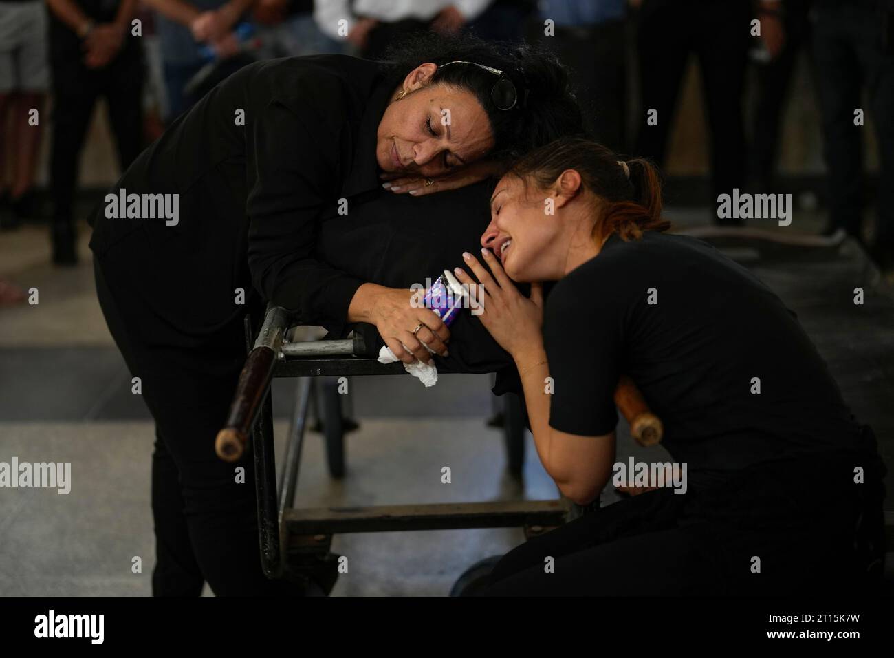 Mourners react beside the body of Mapal Adam, during her funeral in Tel ...