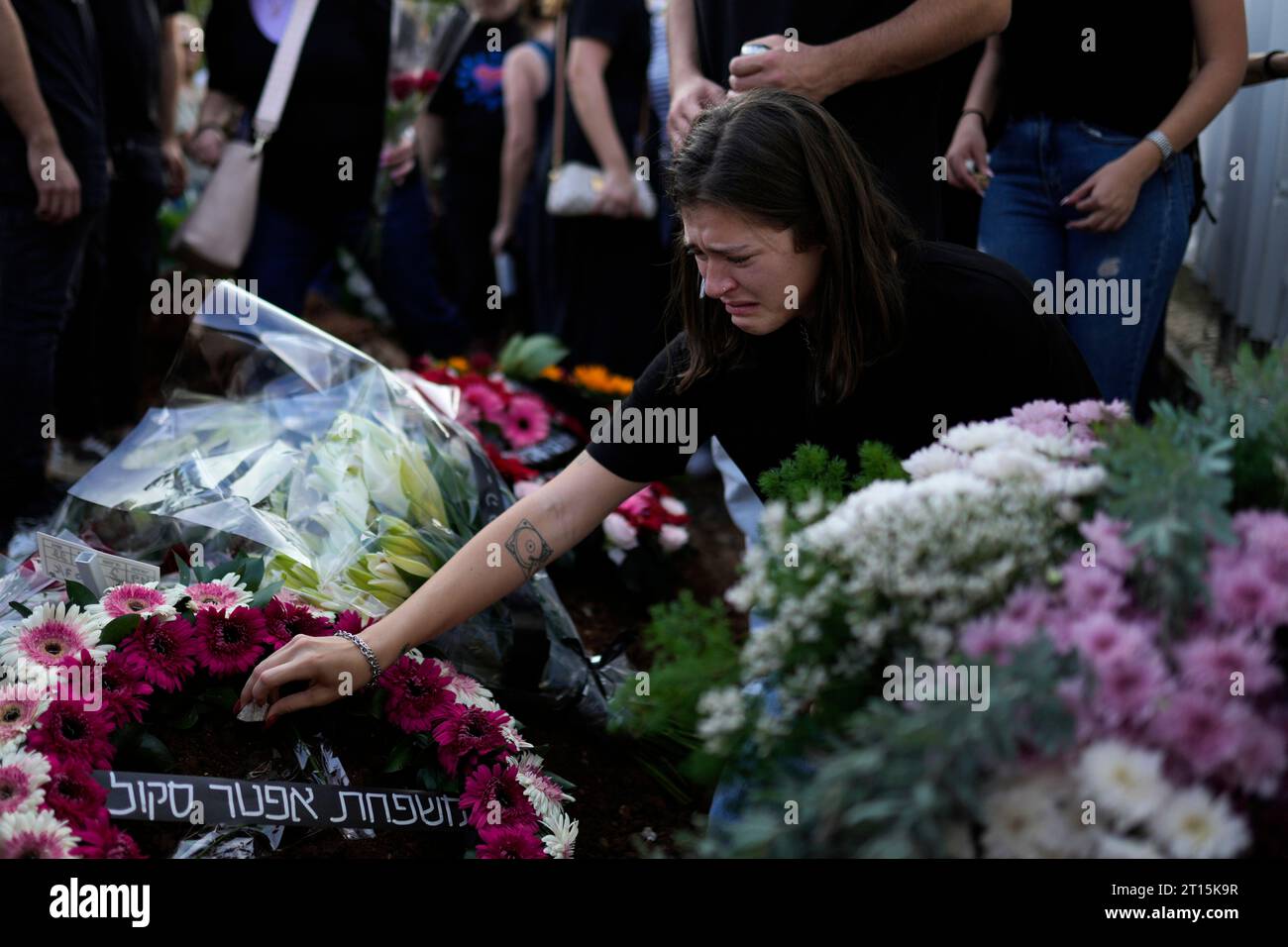 Mourners react beside grave of Mapal Adam, during her funeral in Tel ...