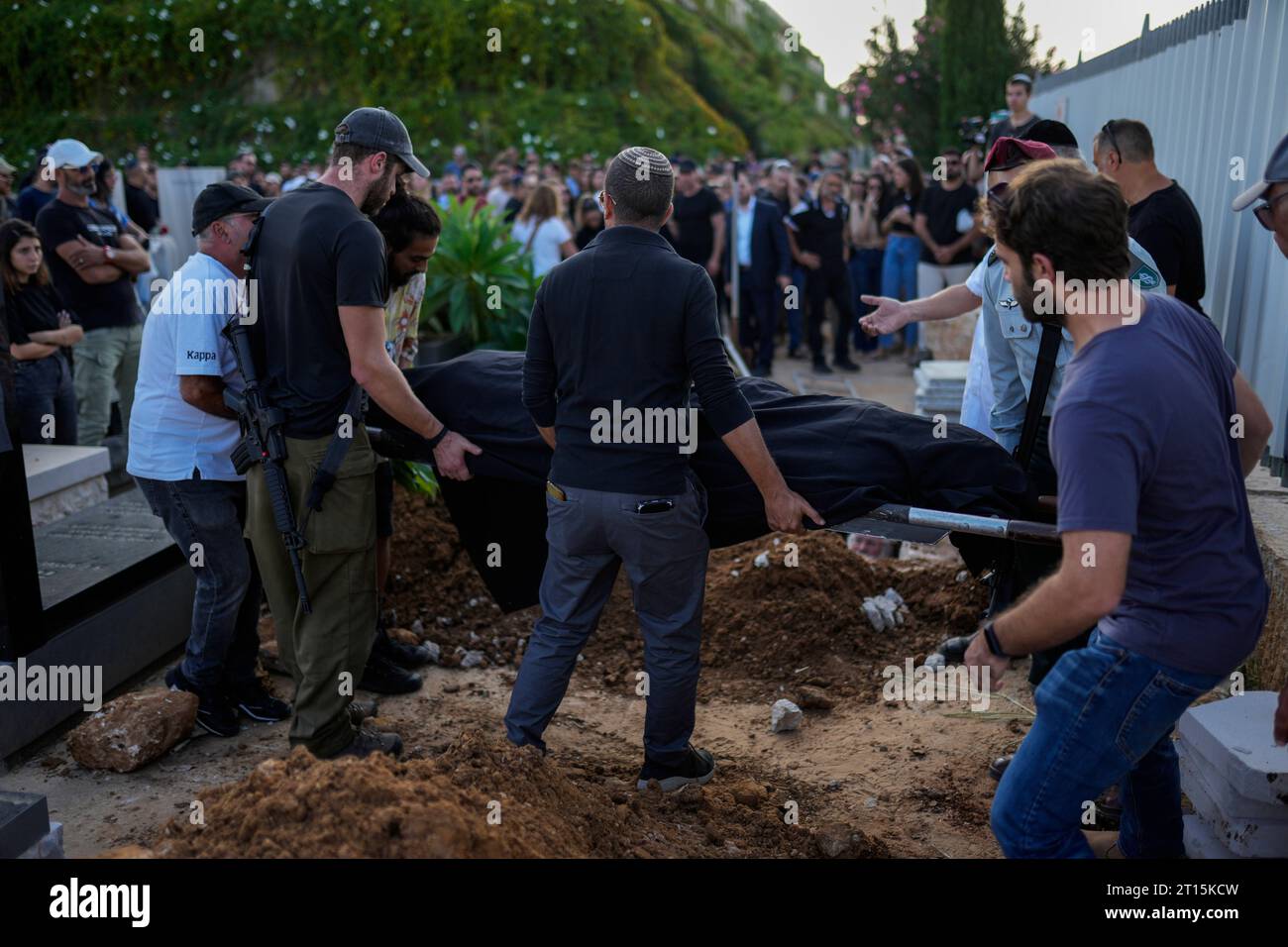 Mourners carry the body of Mapal Adam, during her funeral in Tel Aviv ...