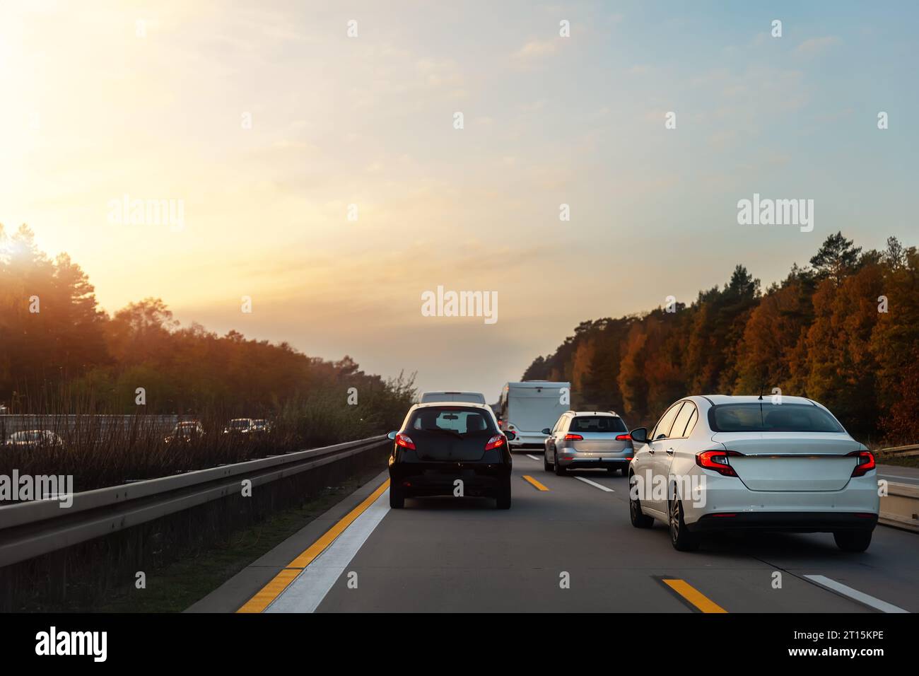 Back tail view of many cars stuck in row at highway city street road ...