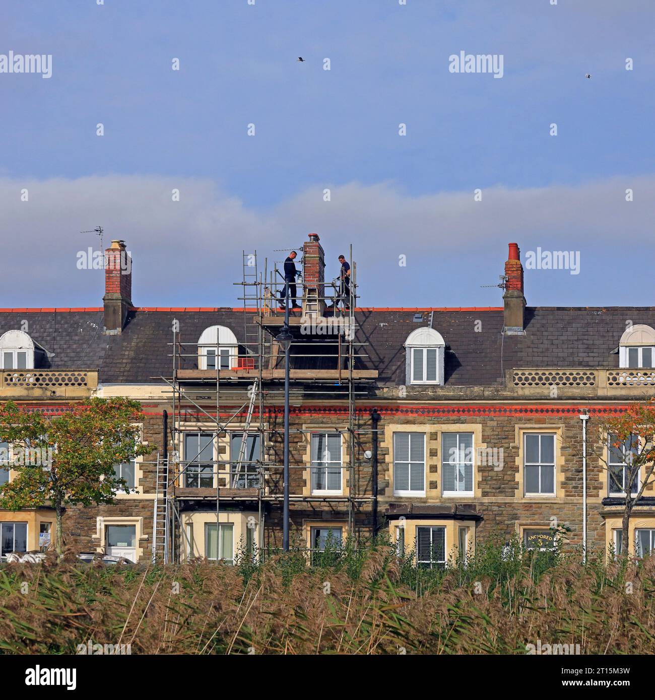 Two men on scaffolding working on a chimney, Windsor Esplanade, Cardiff ...