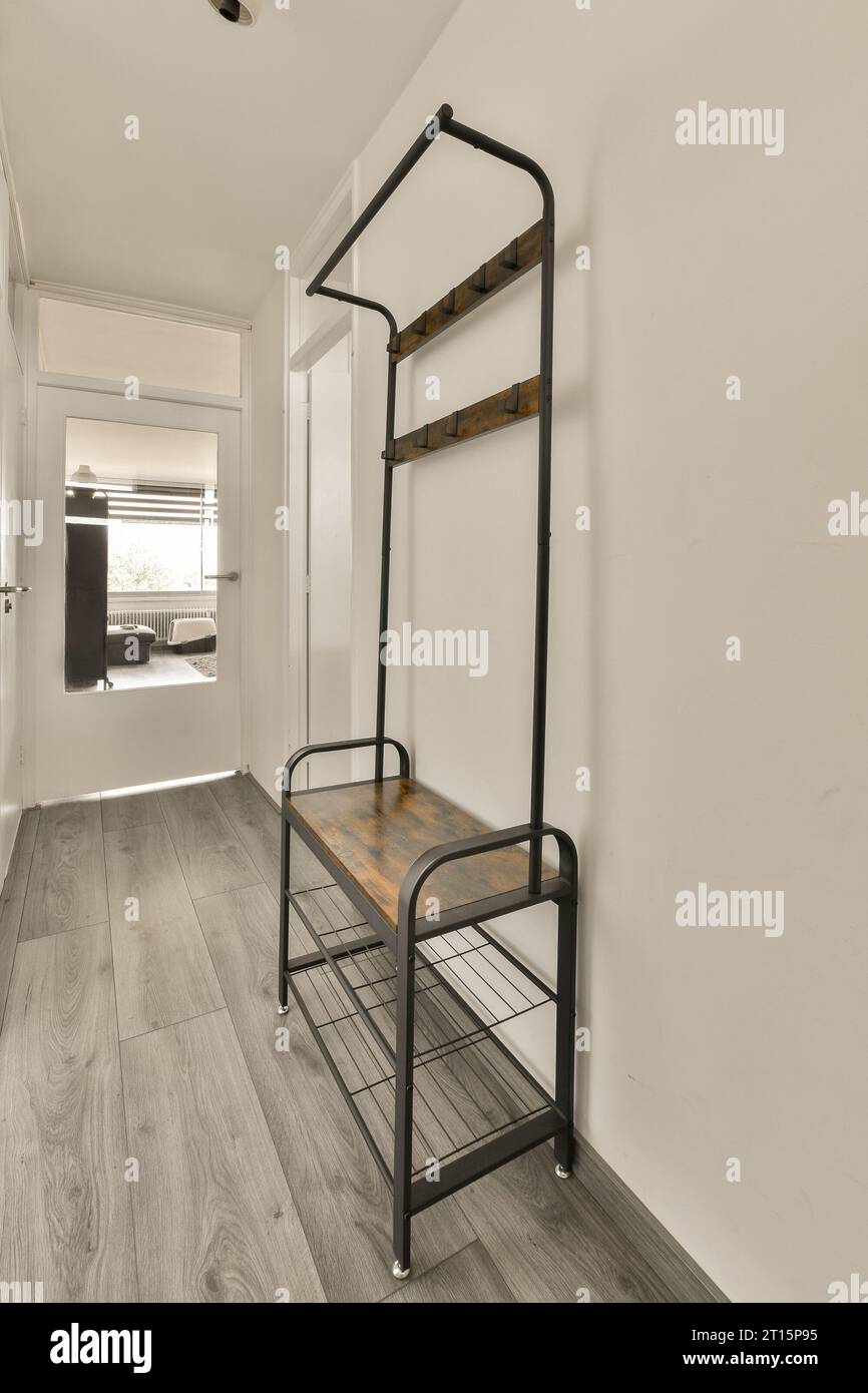 an empty room with wood flooring and white walls, including a black ...