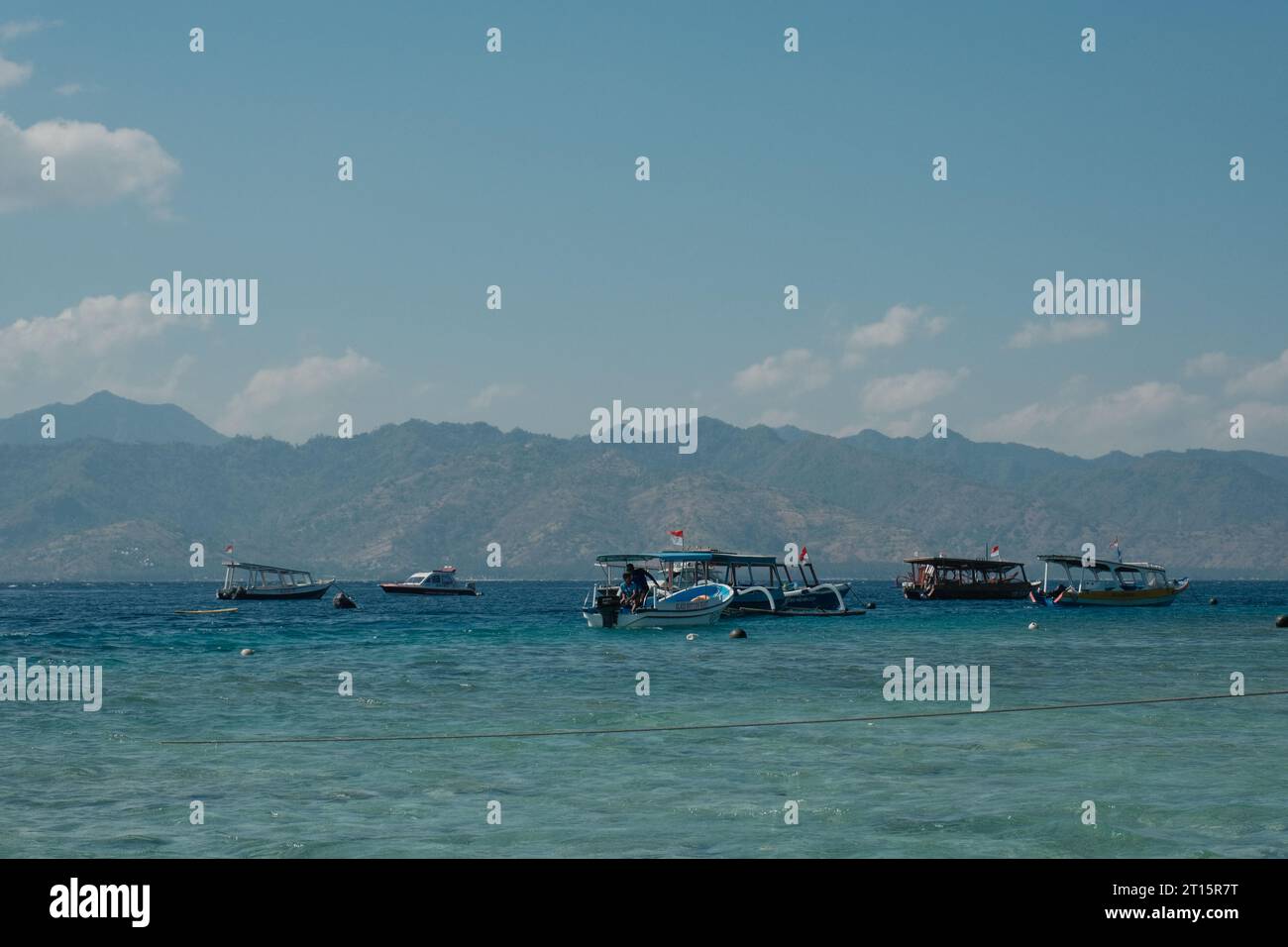 Wade into the pristine turquoise waters of Gili Trawangan. Beyond ...
