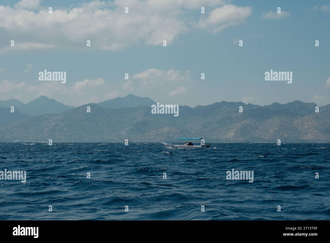 A single boat sails in the endless expanse of Gili Trawangan's open sea ...