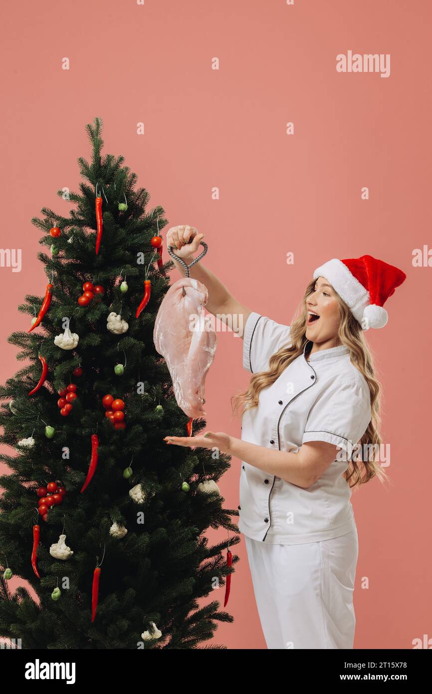 Concept of cooking and Christmas holidays. A beautiful blonde cook in a ...