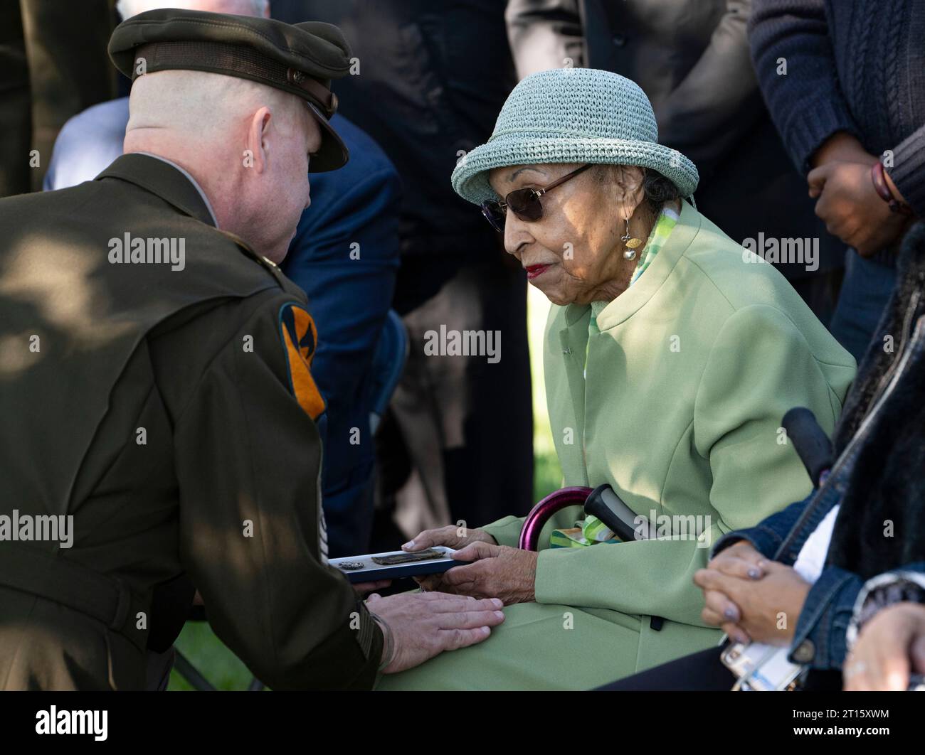 First Army's Command Sgt. Maj. Chris Prosser, left, presents Joann ...