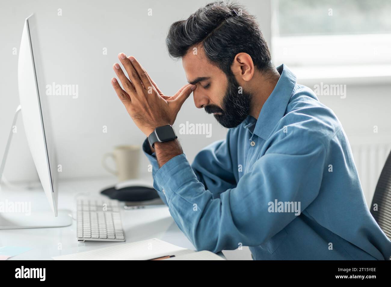 Stressed indian businessman frustrated with work sitting in front of ...