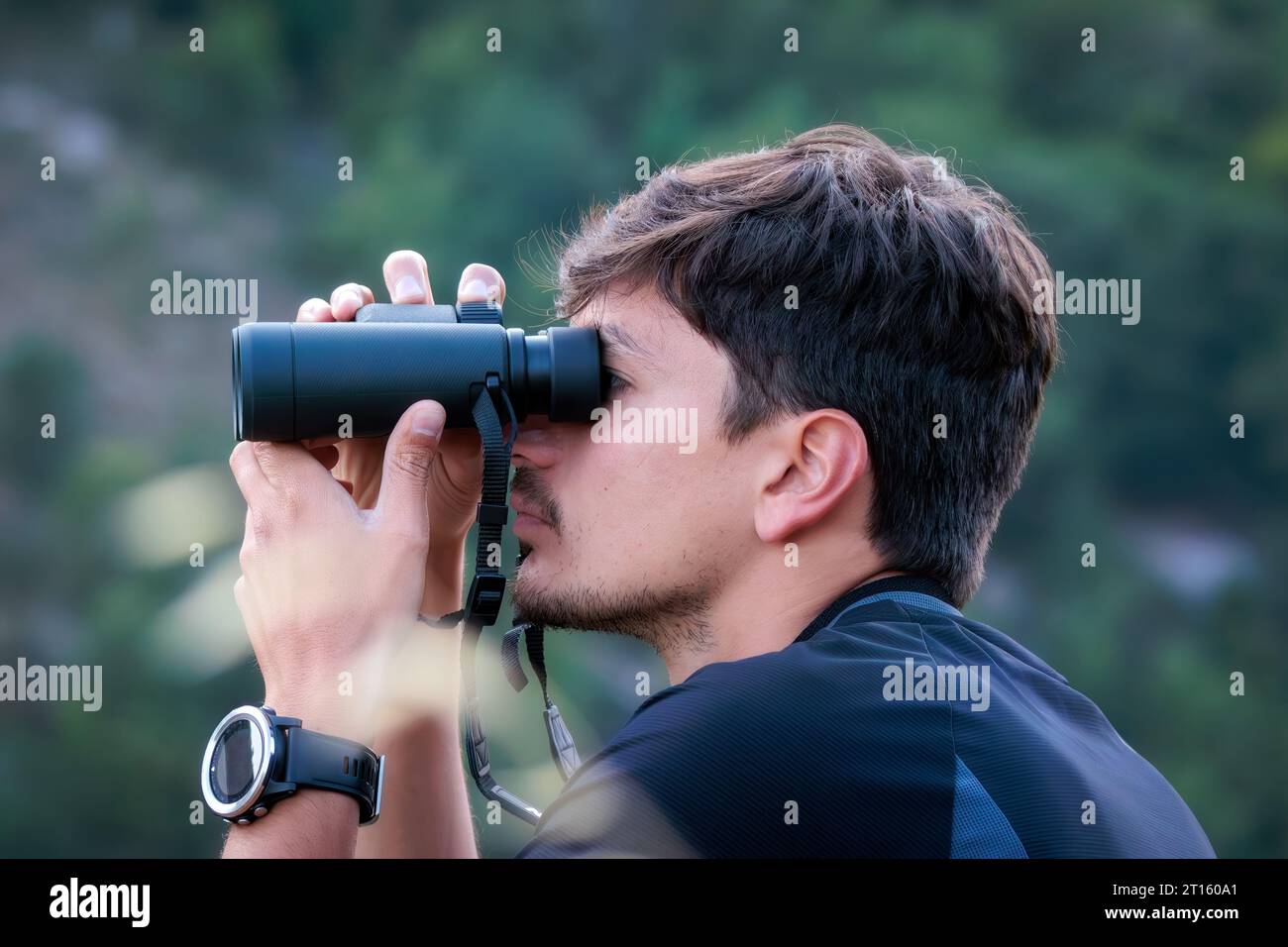 A man observes animals in nature with binoculars. Birdwatching Stock ...