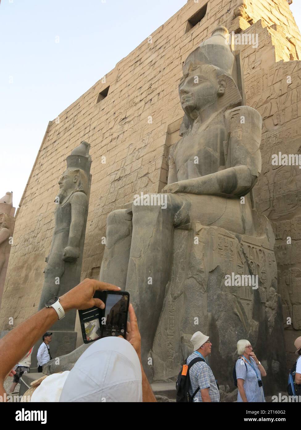 Tourist with a mobile phone tries to capture the scale of the giant ...