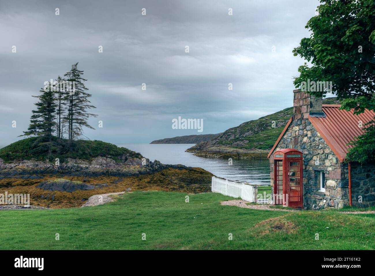 Red traditional phone booth at the edge of Loch Inver, Sutherland ...