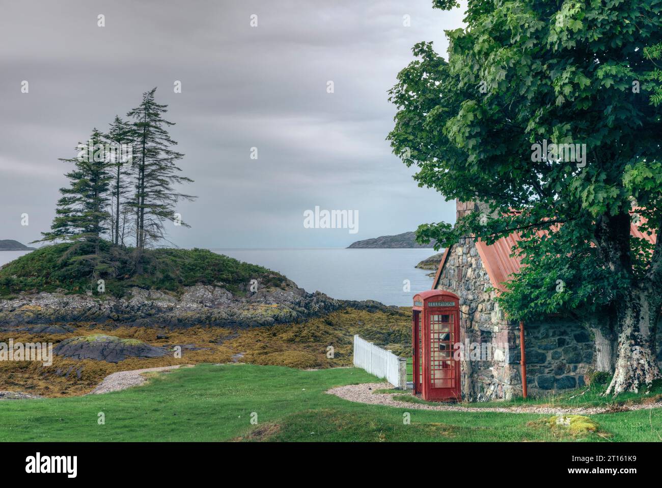 Red traditional phone booth at the edge of Loch Inver, Sutherland ...