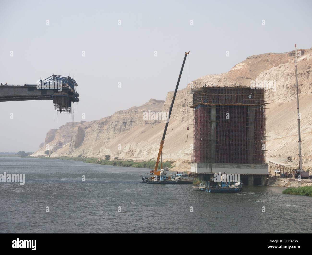 A new, massive bridge construction is underway at Manfalut to connect ...