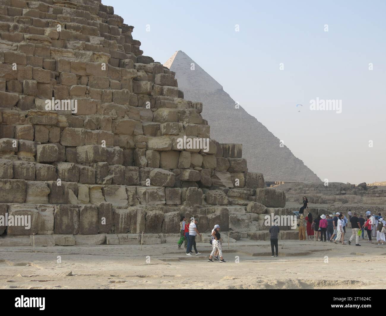 Tourists throng at the base of one of the pyramids at the Giza Pyramid ...