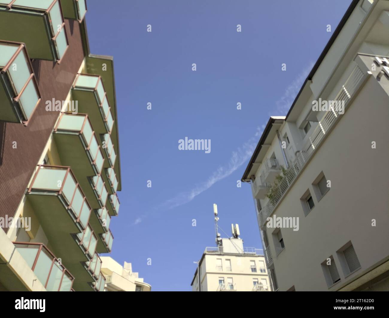 Two buildings side by side with balconies by their sides on a sunny day ...