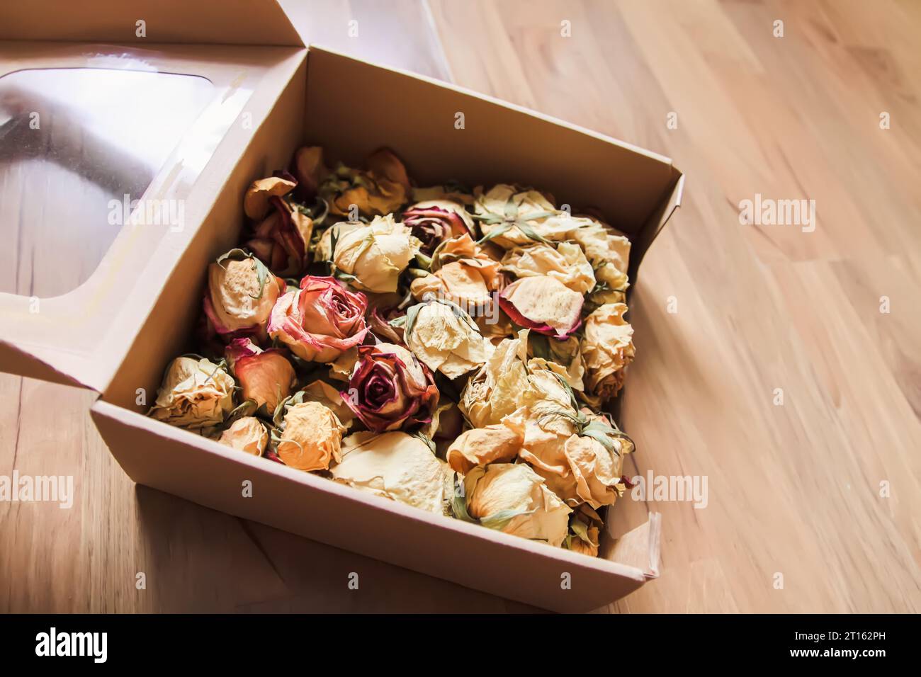 Dried rose flowers and petals in the cardboard box. Floral decor Stock ...