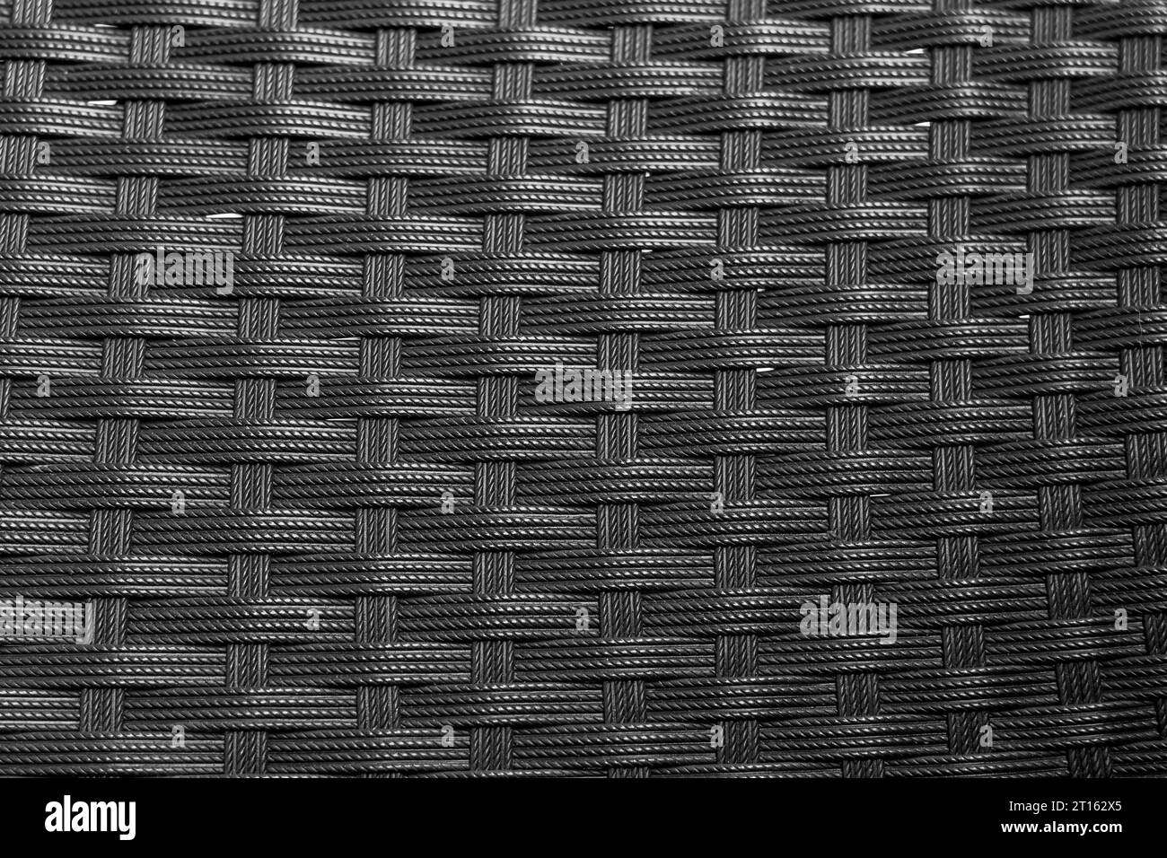 Black background made of plastic-like material with criss-cross meshes ...