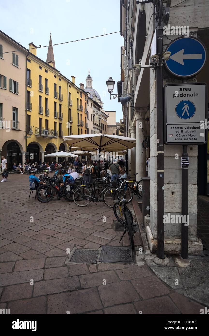 Cobbled square bordered by buildings with porchways in an italian town ...