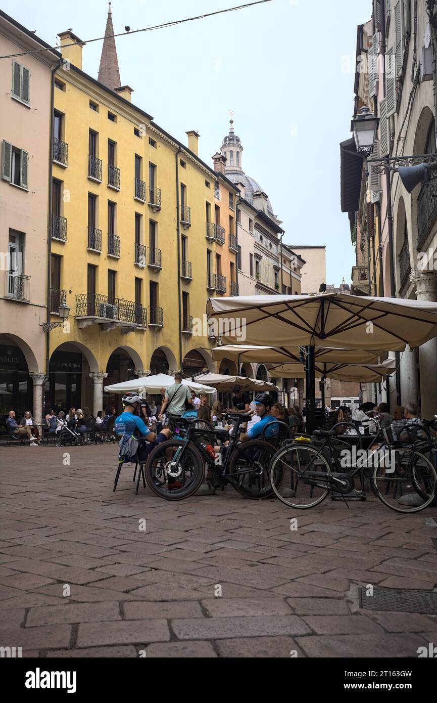 Cobbled square bordered by buildings with porchways in an italian town ...
