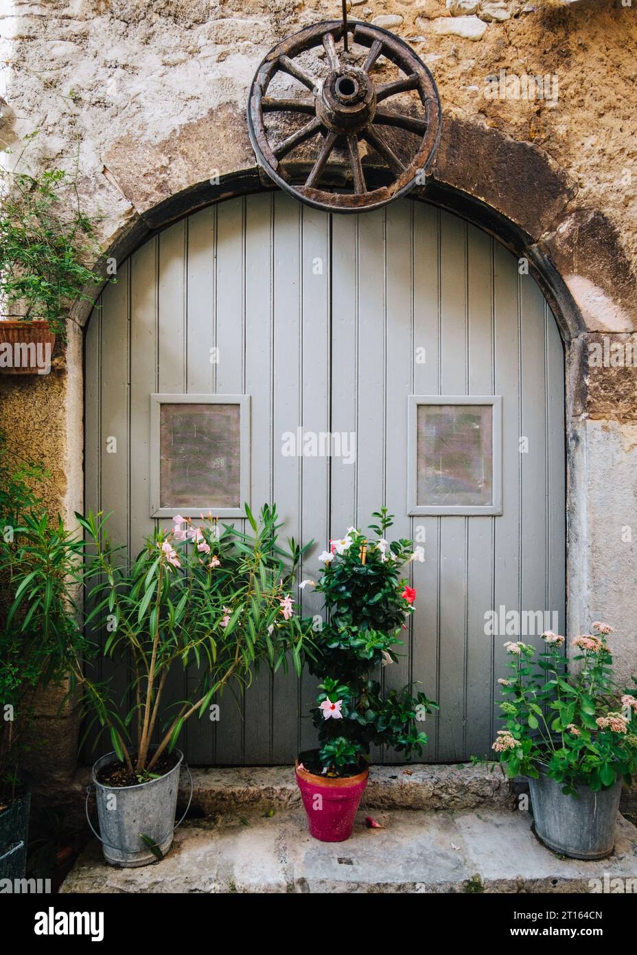 Quaint garage door with flower pots in the medieval street of Chatillon ...