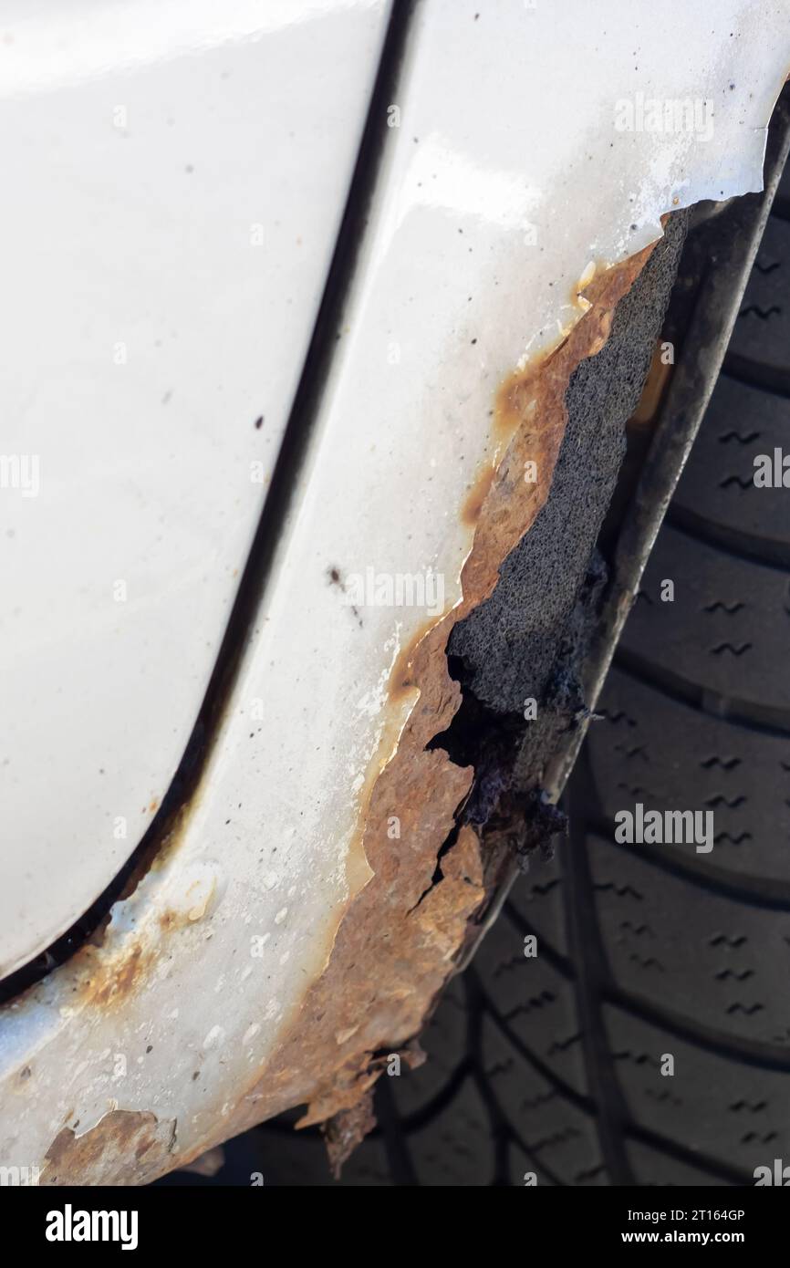 Rotten sills of an old gray car close up Stock Photo - Alamy