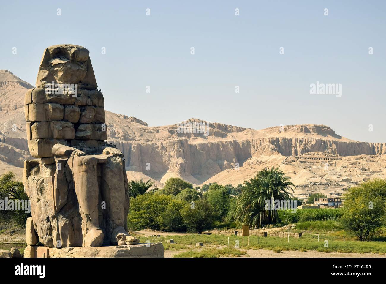 The Colossi of Memnon, one of the two massive stone statues of Pharaoh ...