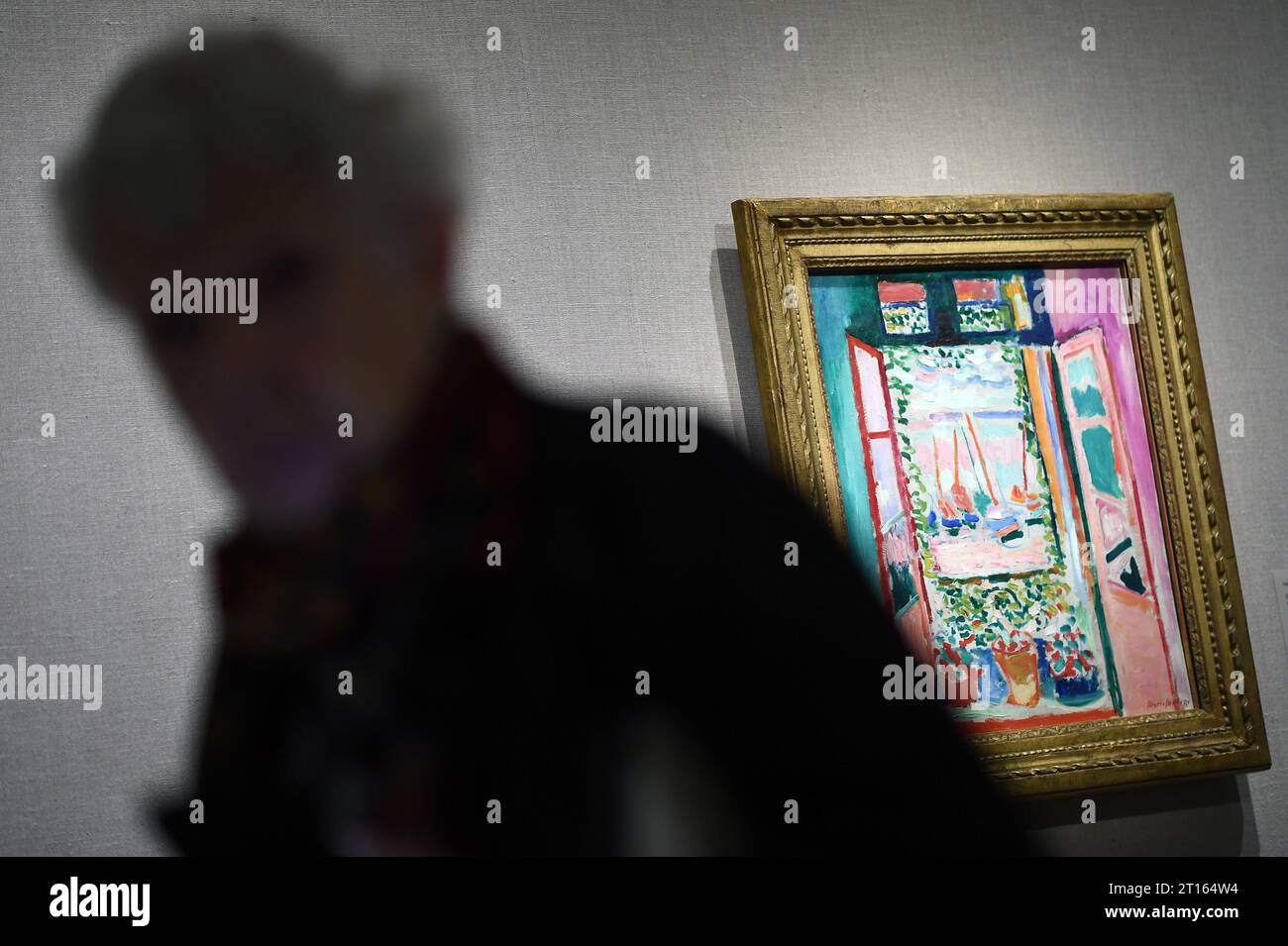 New York, USA. 11th Oct, 2023. A woman walks past the painting “Open ...
