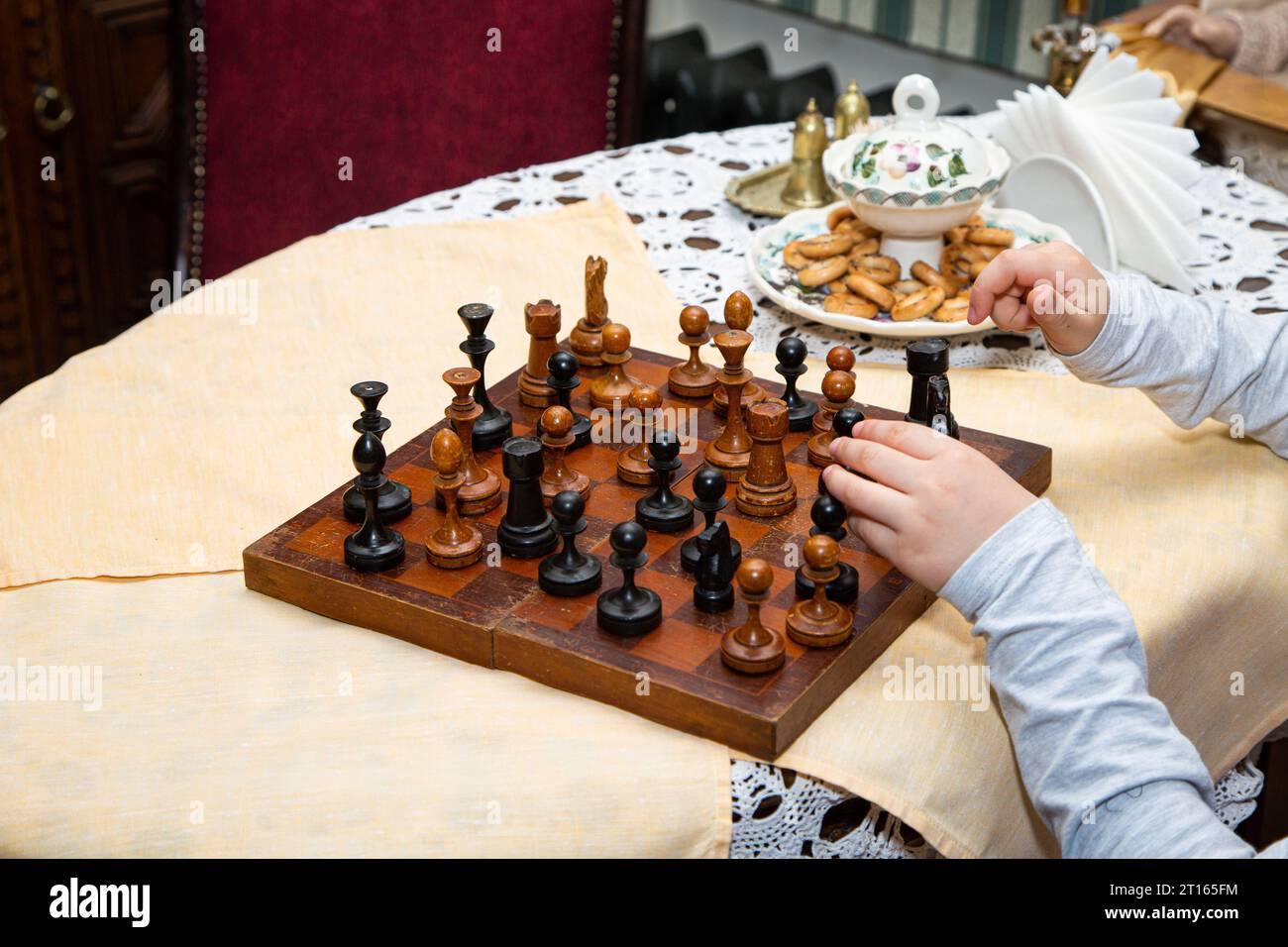 kids playing wooden chess pieces in the house Stock Photo - Alamy