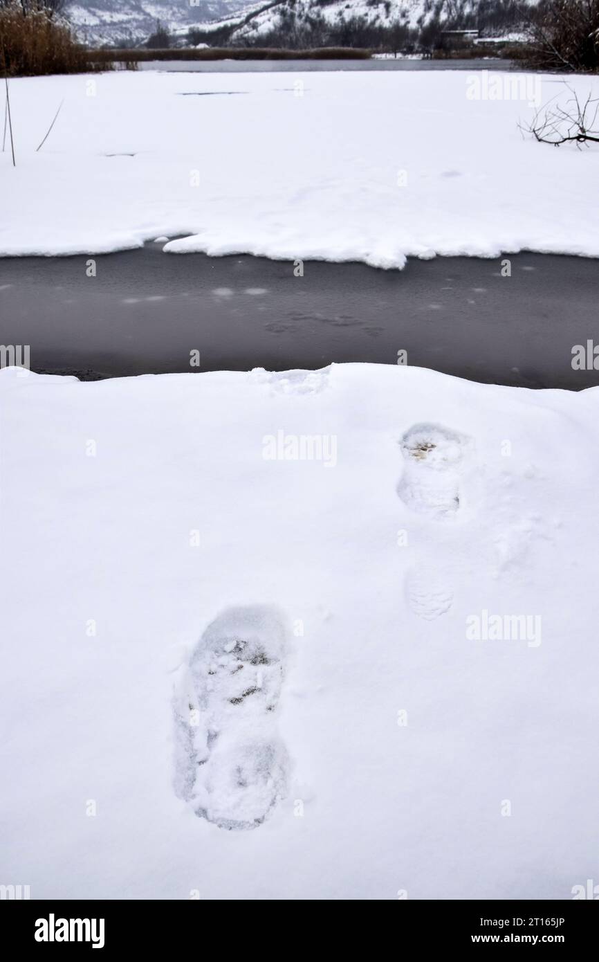 Shoe prints on fresh snow, footprints, men's footsteps. An obstacle in ...