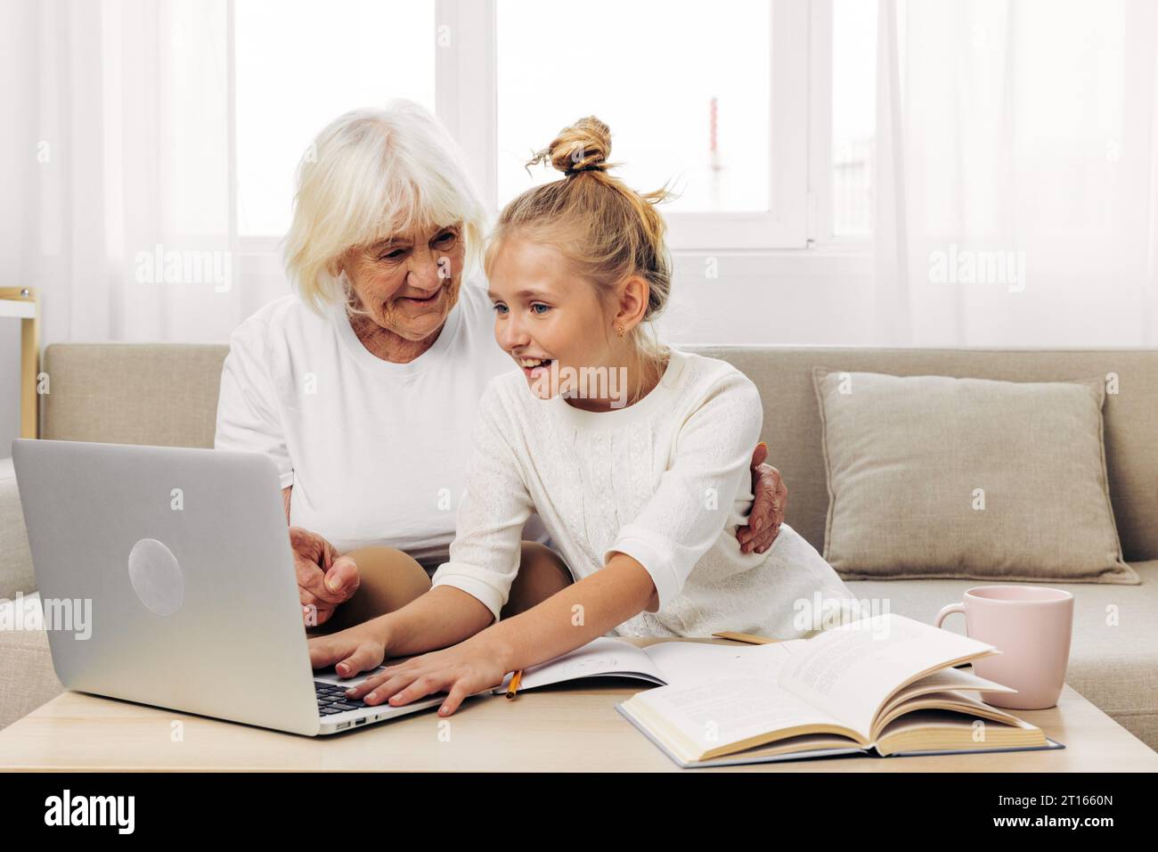 Grandmother child family hugging laptop Stock Photo - Alamy