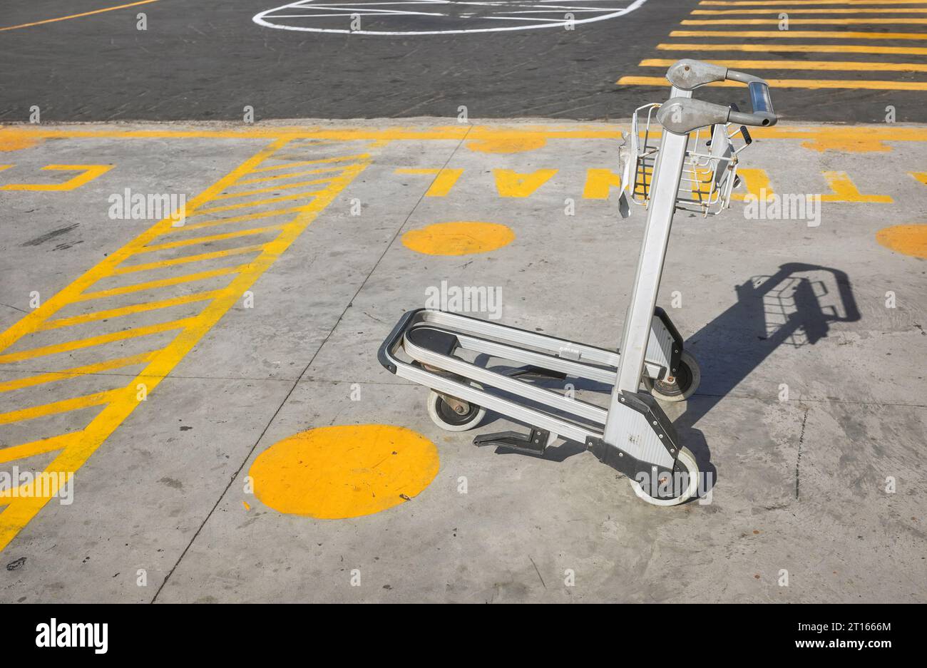 Luggage cart or airport trolley in an empty parking lot, selective ...