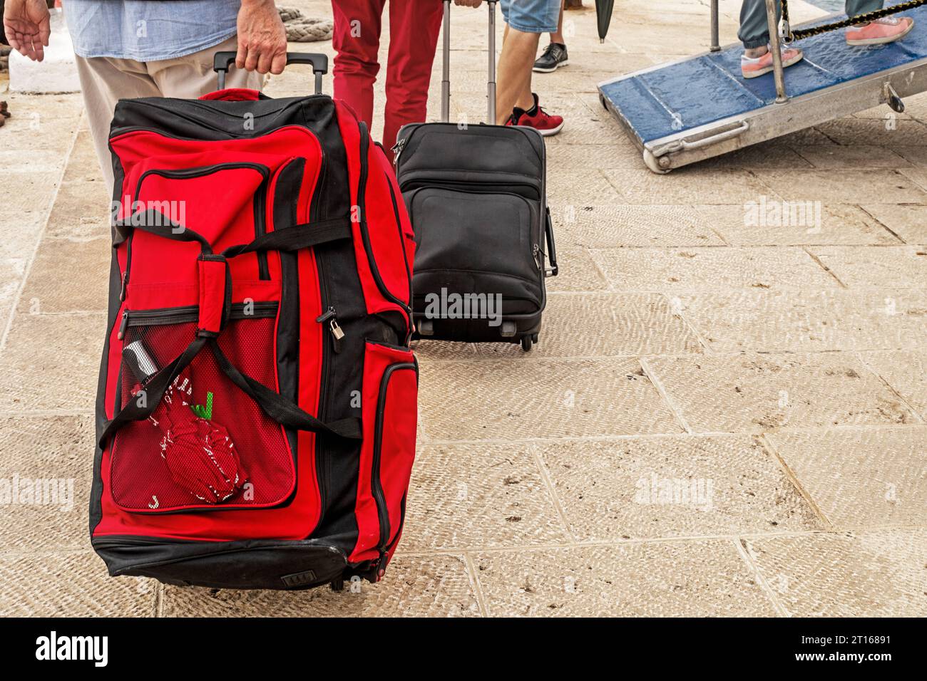 passengers carry suitcases along the pier to the liner. Refugees, war ...