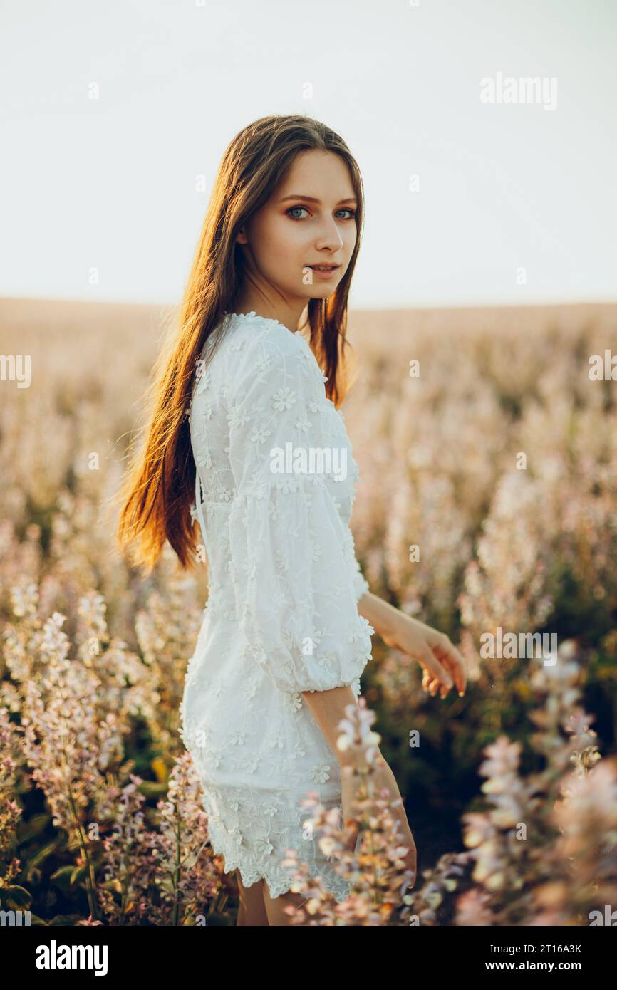 Lady in a White Dress Amidst a Sage Field at Sunset Stock Photo - Alamy