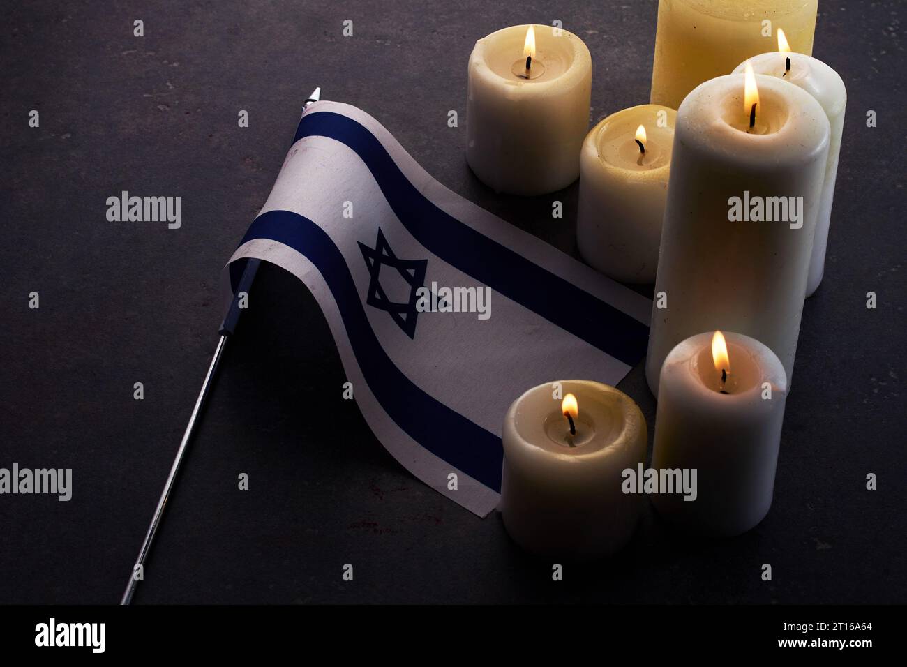 Burning candles and flag of Israel on dark background. Holocaust ...