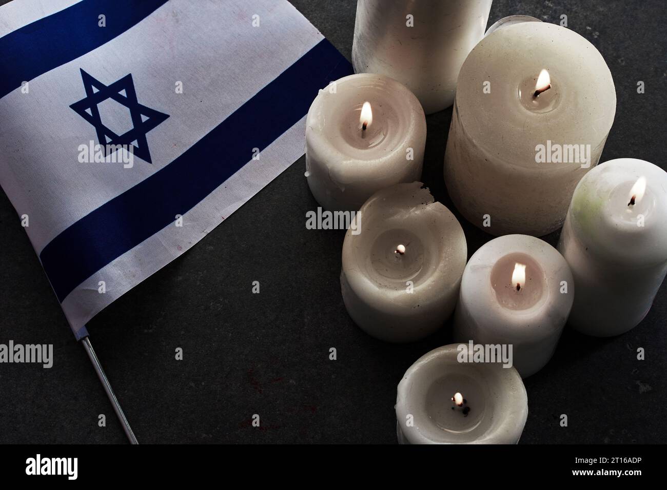 Burning candles and flag of Israel on dark background. Holocaust ...