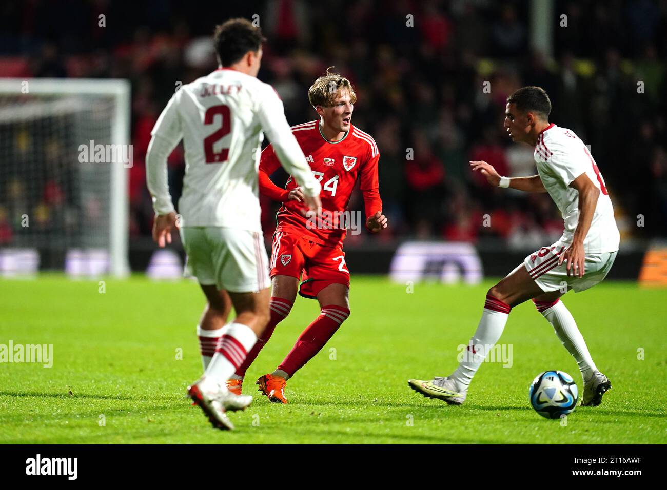 Wales' Charlie Savage (centre) battles for the ball with Gibraltar's ...