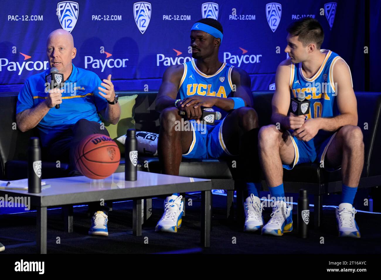 UCLA head coach Mick Cronin speaks beside players Adem Bona, center ...