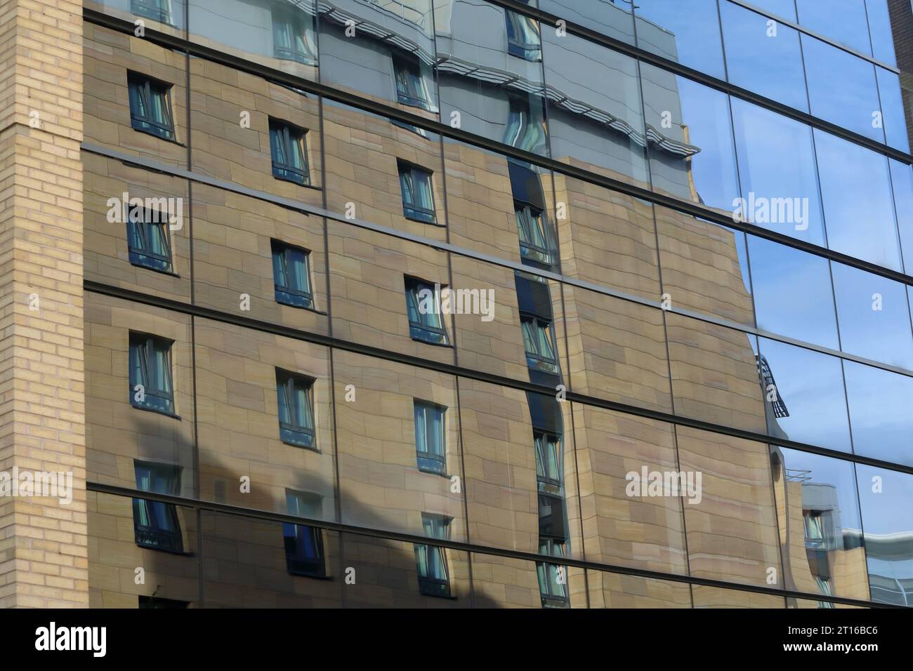 reflections of a building in the windows of another Stock Photo - Alamy