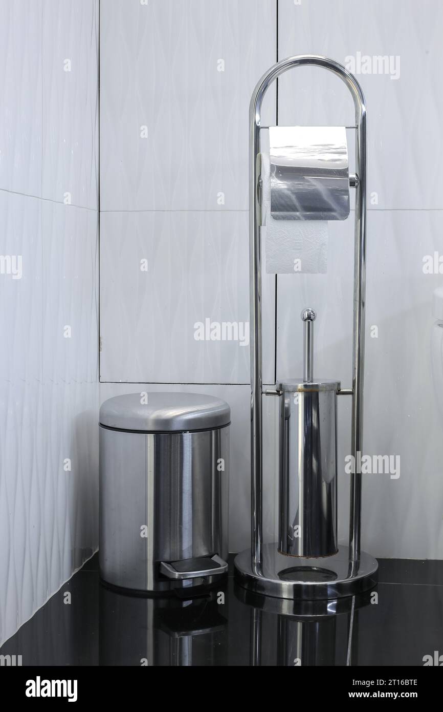 Chrome trash can; toilet paper; brush in the toilet room Stock Photo ...