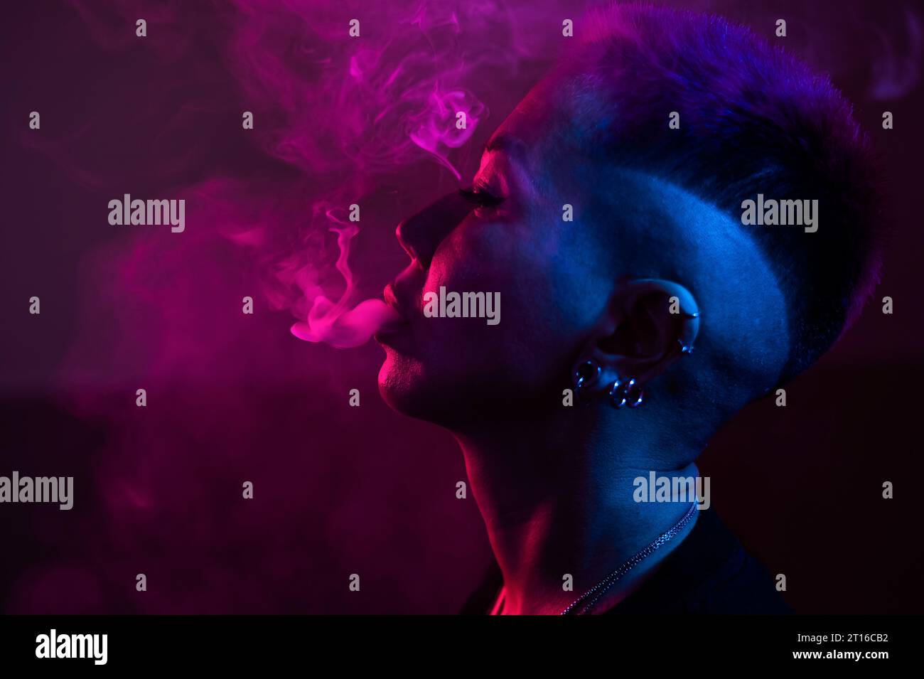 Profile Asian woman with short haircut smoking in neon light Stock ...