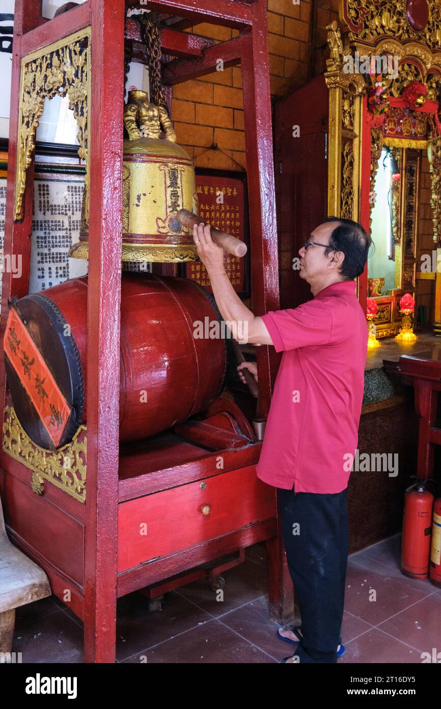 Can Tho, Vietnam. Worshipper Striking Temple Bell and Drum, Ong Temple ...